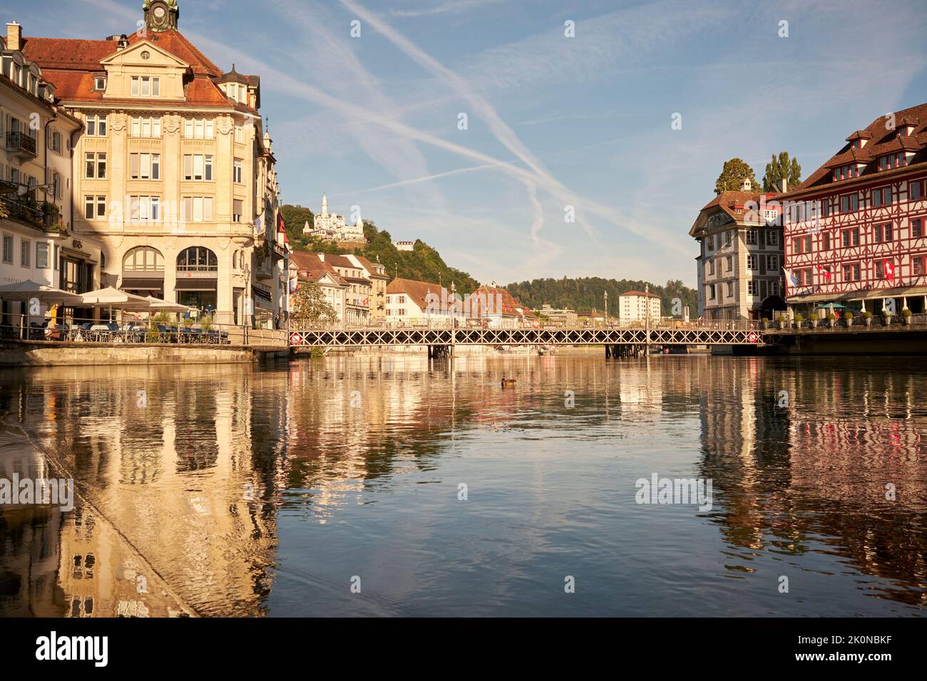 Scenic cityscape with footbridge over river near old buildings Stock ...