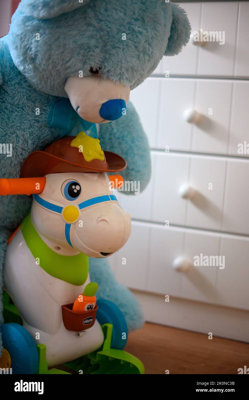 teddy bear riding on a toy horse in children's room Stock Photo - Alamy