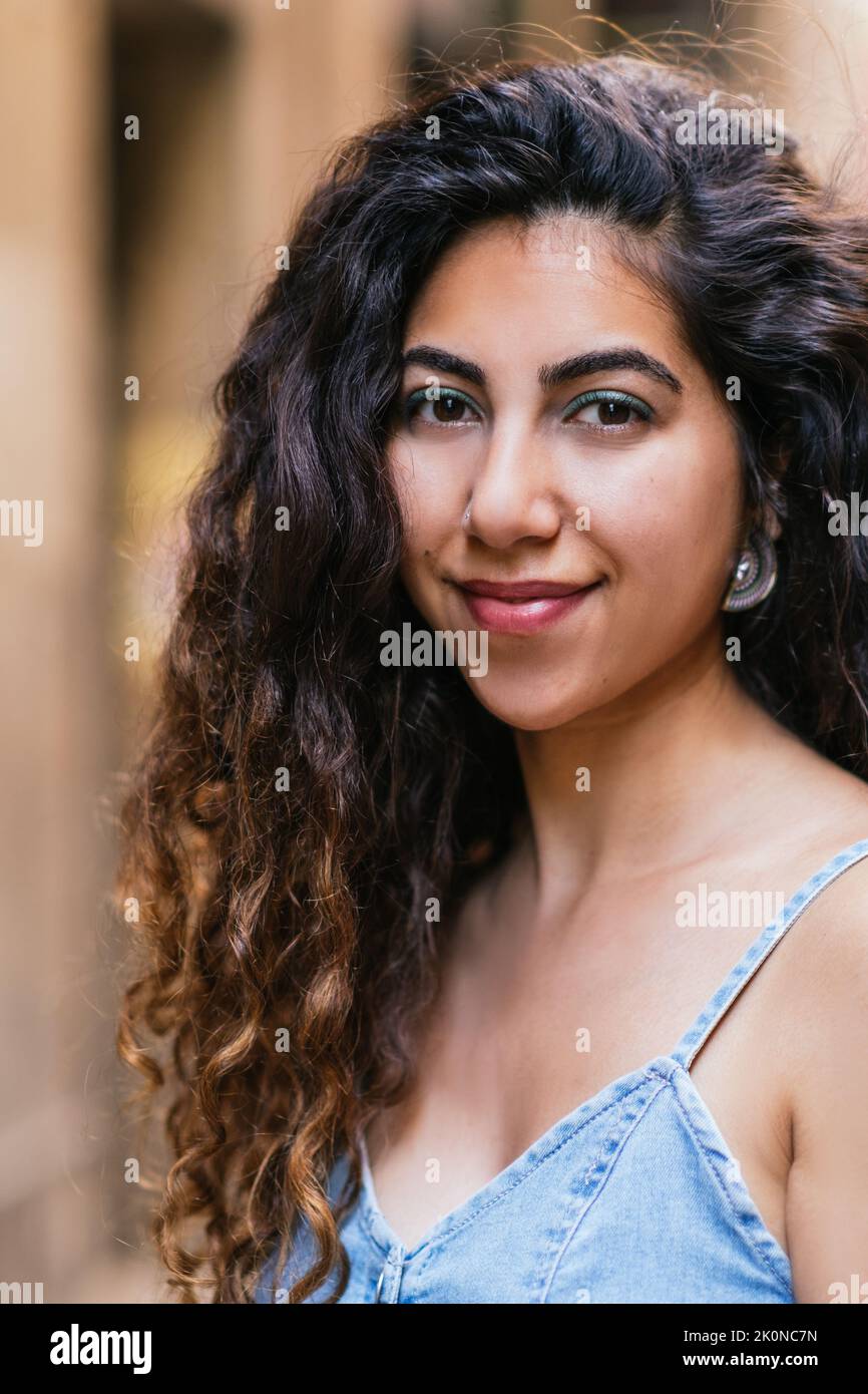vertical portrait of an attractive arabic woman dressing denim dress ...