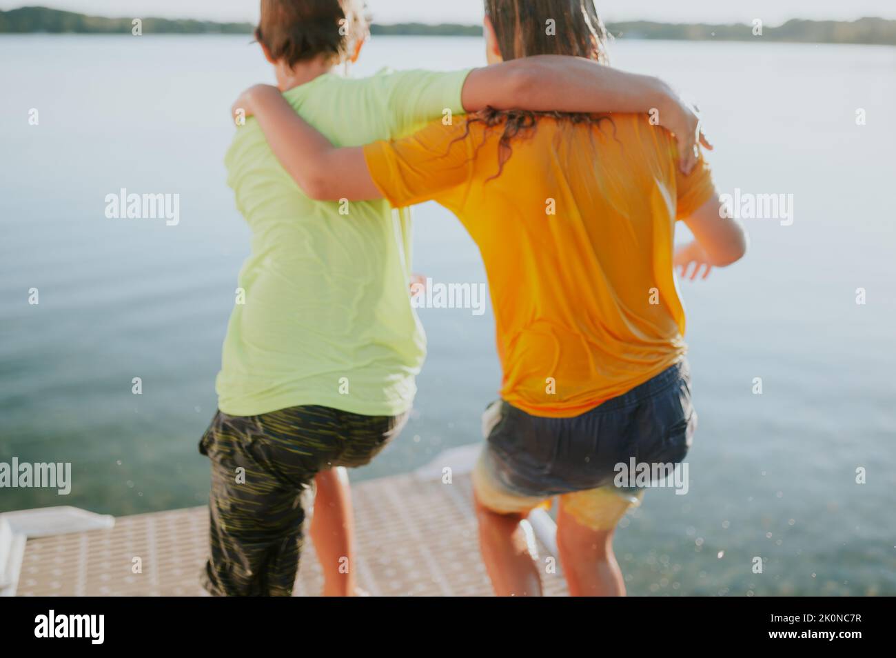 Kids jumping off dock lake hi-res stock photography and images - Alamy