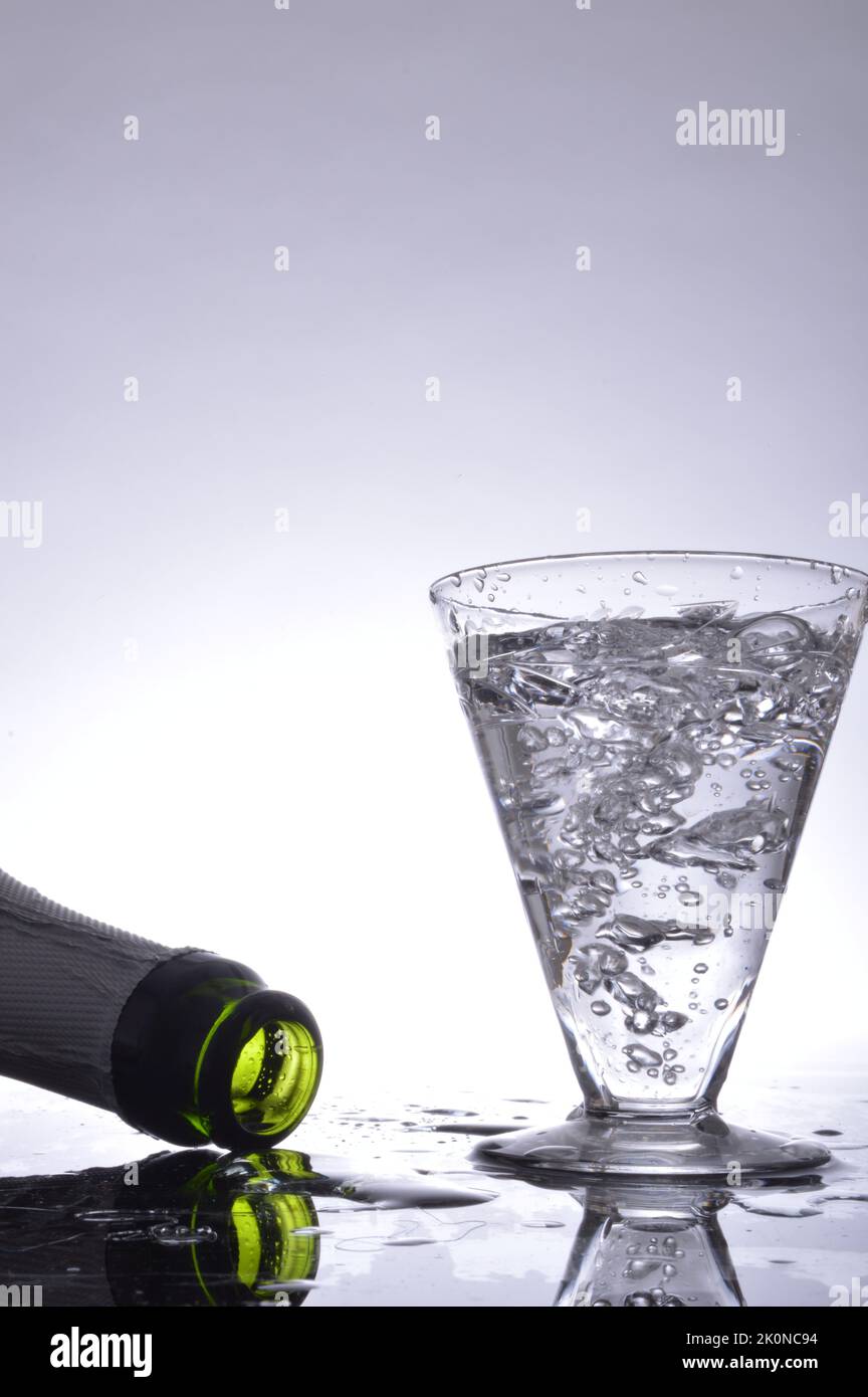 Glass of bubbling champagne and bottle Stock Photo - Alamy