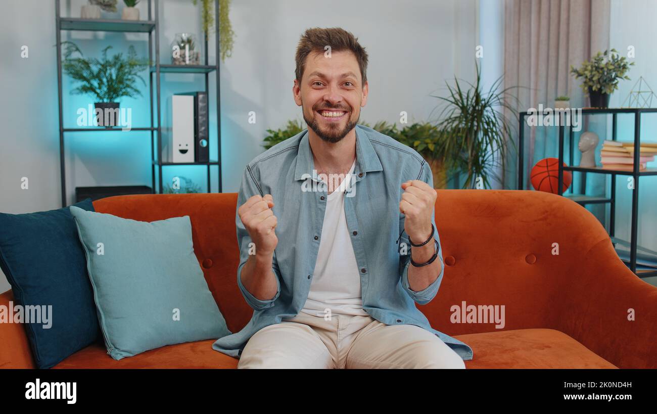 Happy caucasian man shouting, celebrating success, winning, goal ...