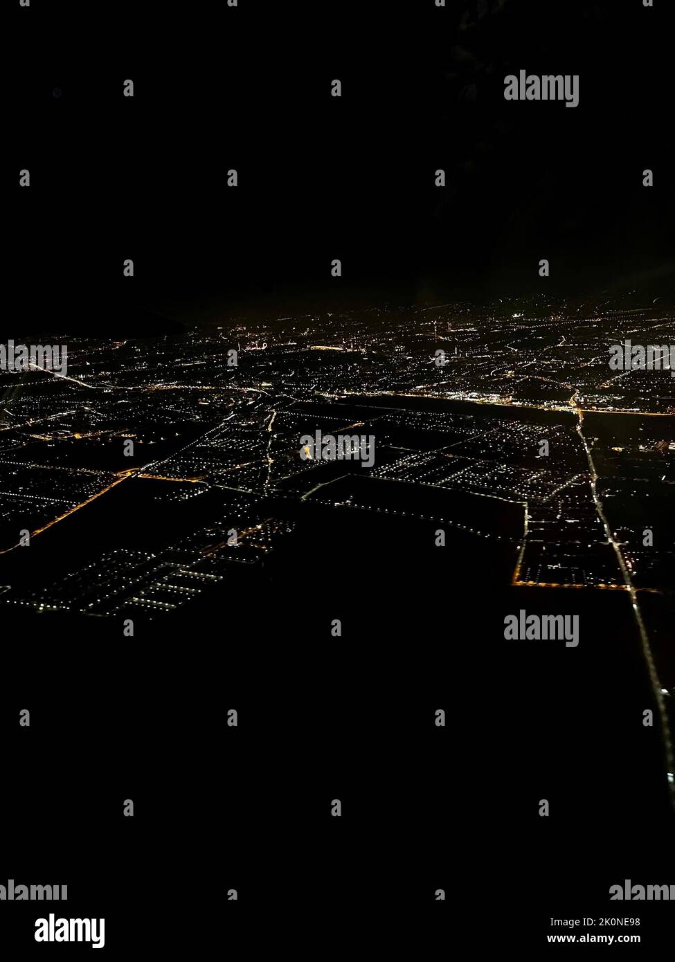 A vertical view of a land captured from an airplane during nighttime ...