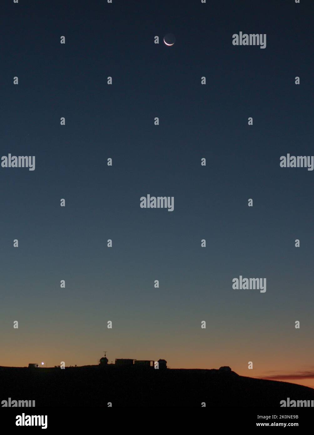 A mesmerizing vertical view of a scenic sunset above a hill Stock Photo ...