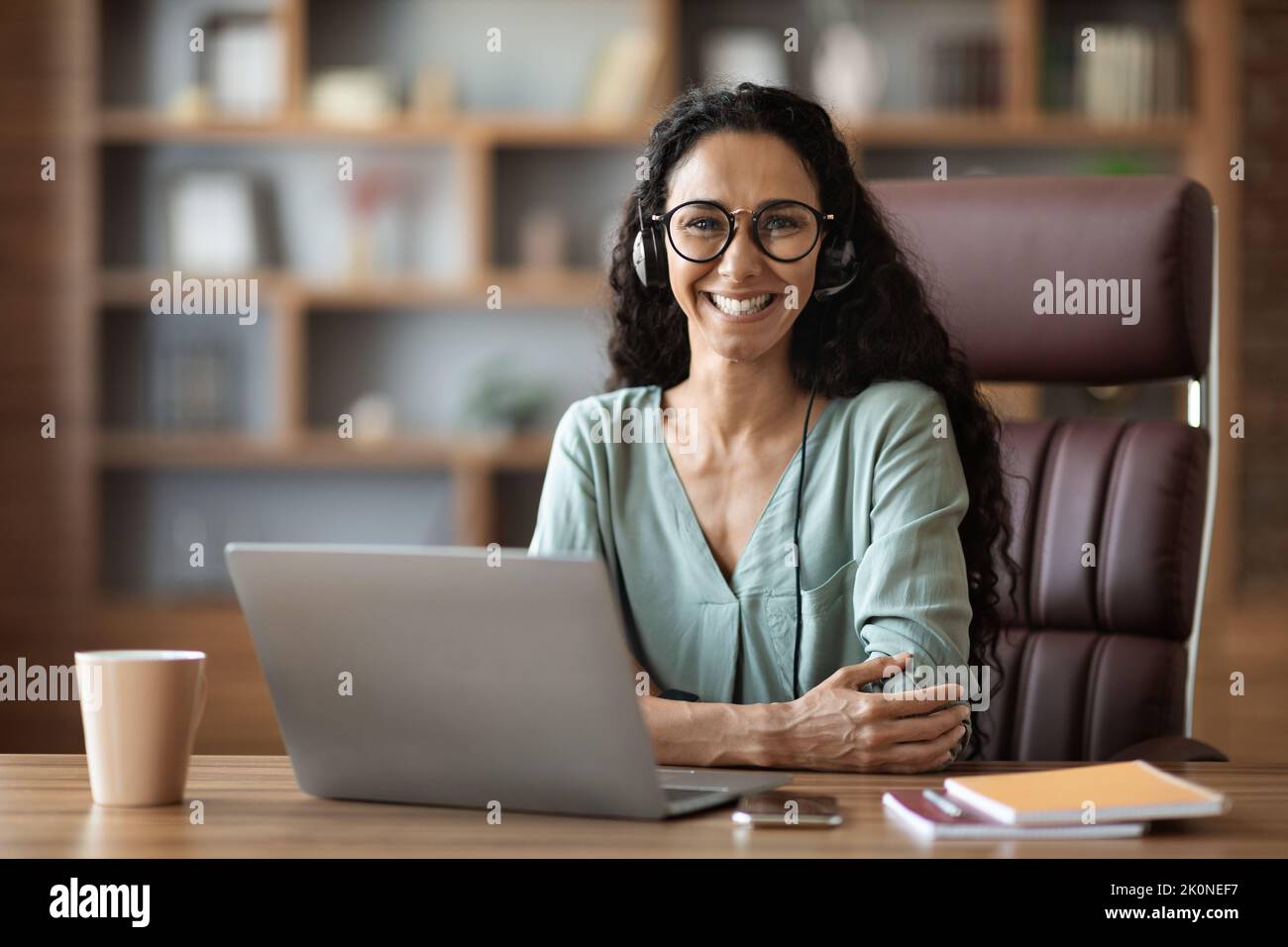 Cheerful lady customer service representative posing at workplace Stock ...