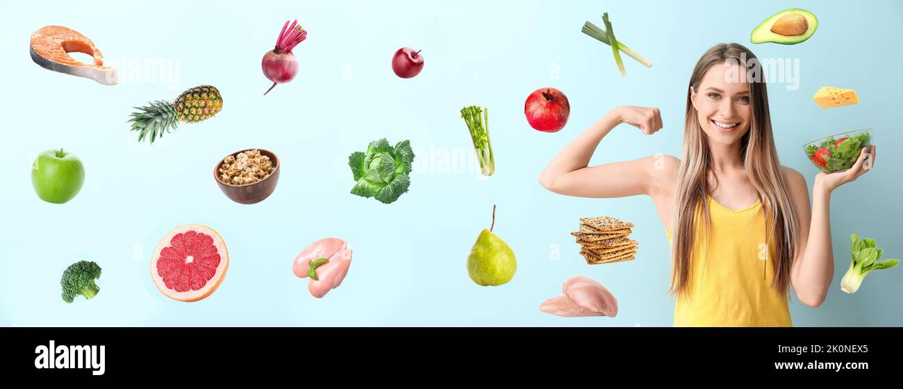 Happy woman with healthy salad and different products on light blue ...