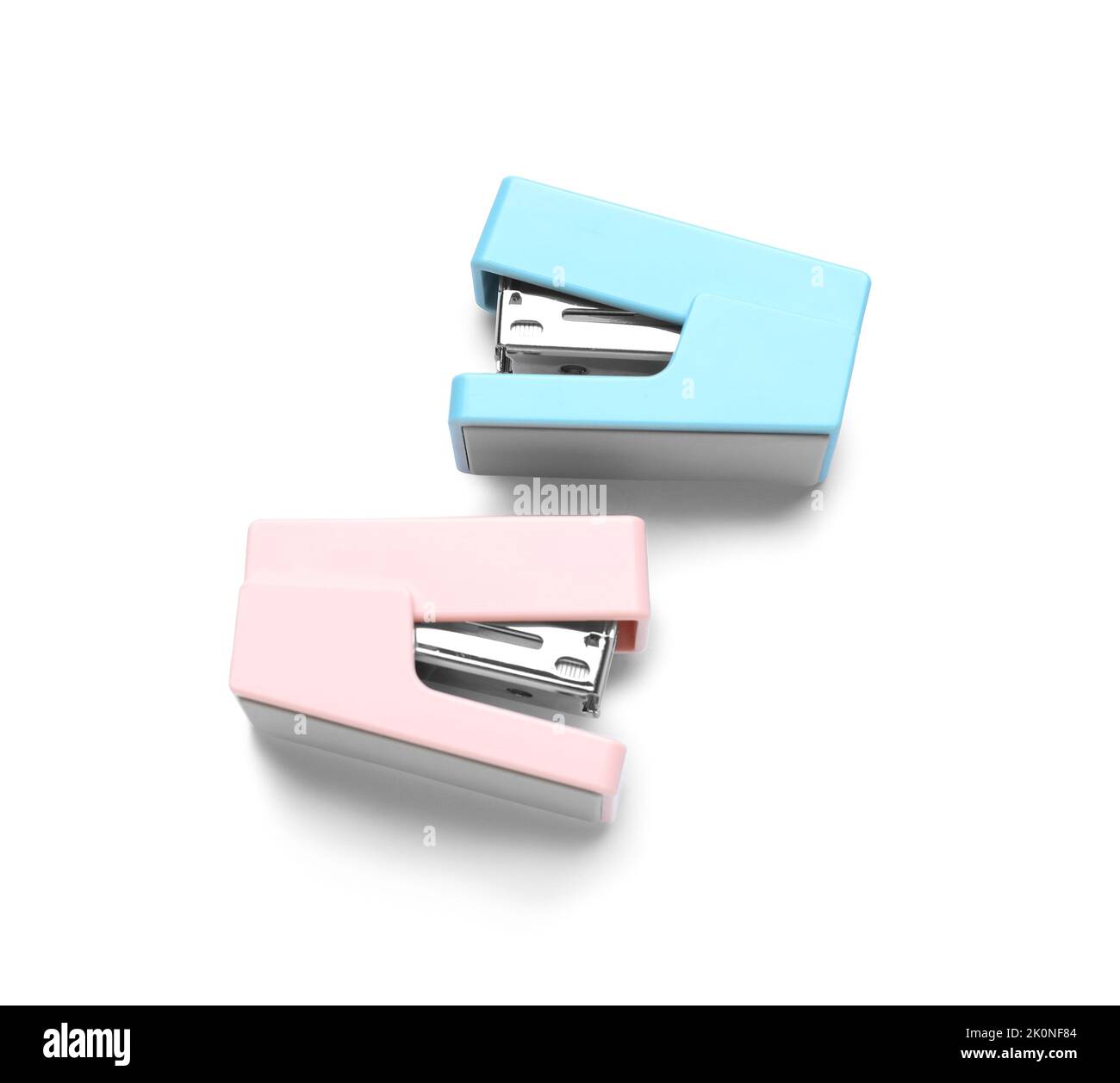 Two colorful staplers on white background Stock Photo - Alamy