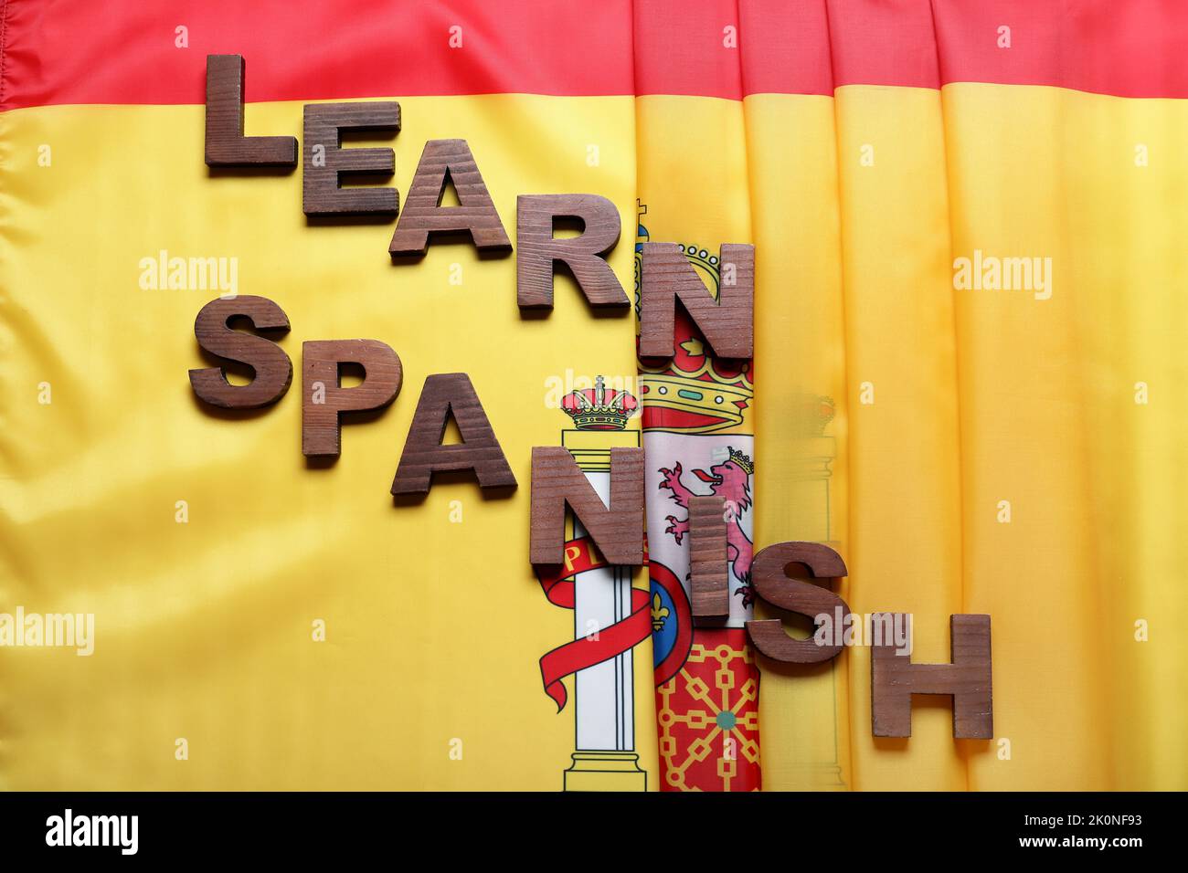 Text LEARN SPANISH on flag of Spain Stock Photo - Alamy