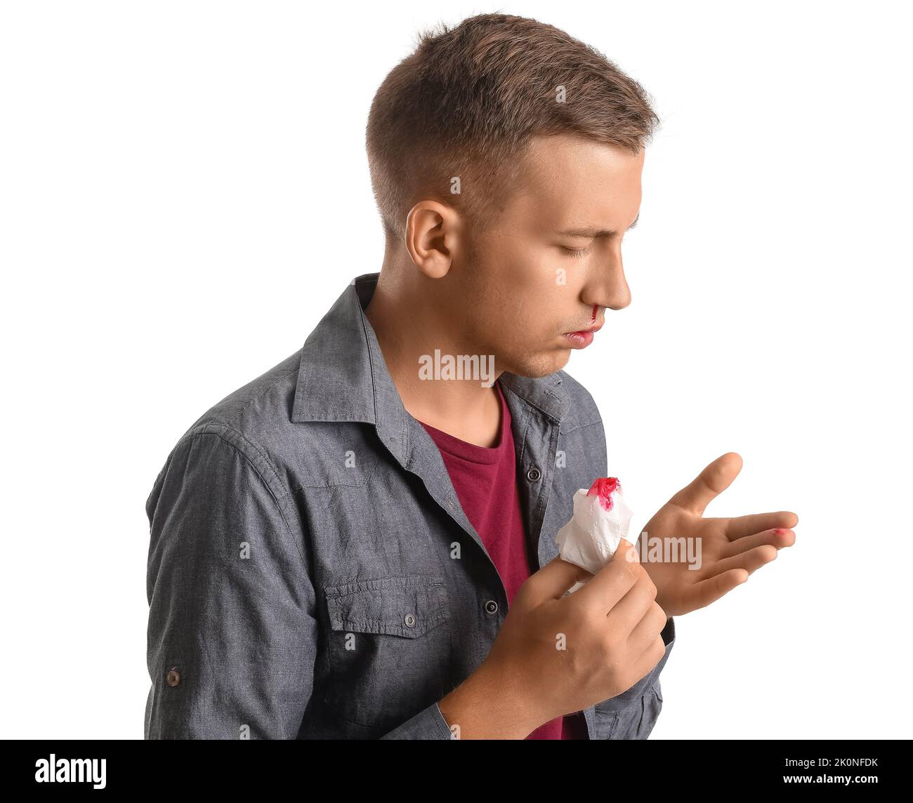 Young man with nosebleed and tissue on white background Stock Photo - Alamy