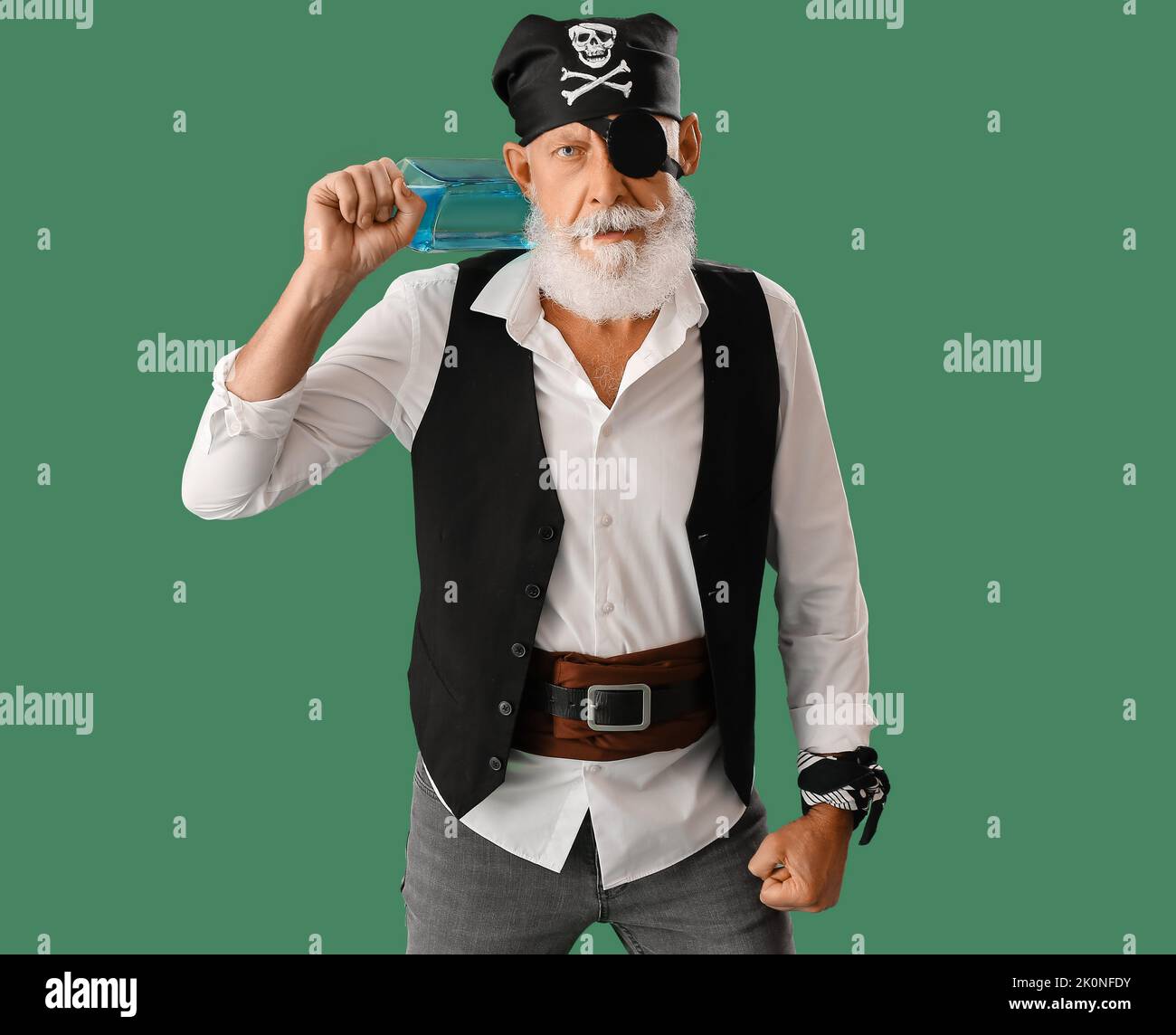 Old pirate with bottle of rum on green background Stock Photo - Alamy