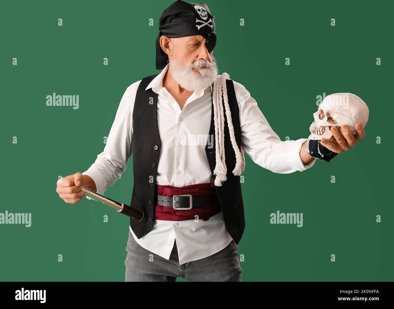 Old pirate with spyglass and human skull on green background Stock ...