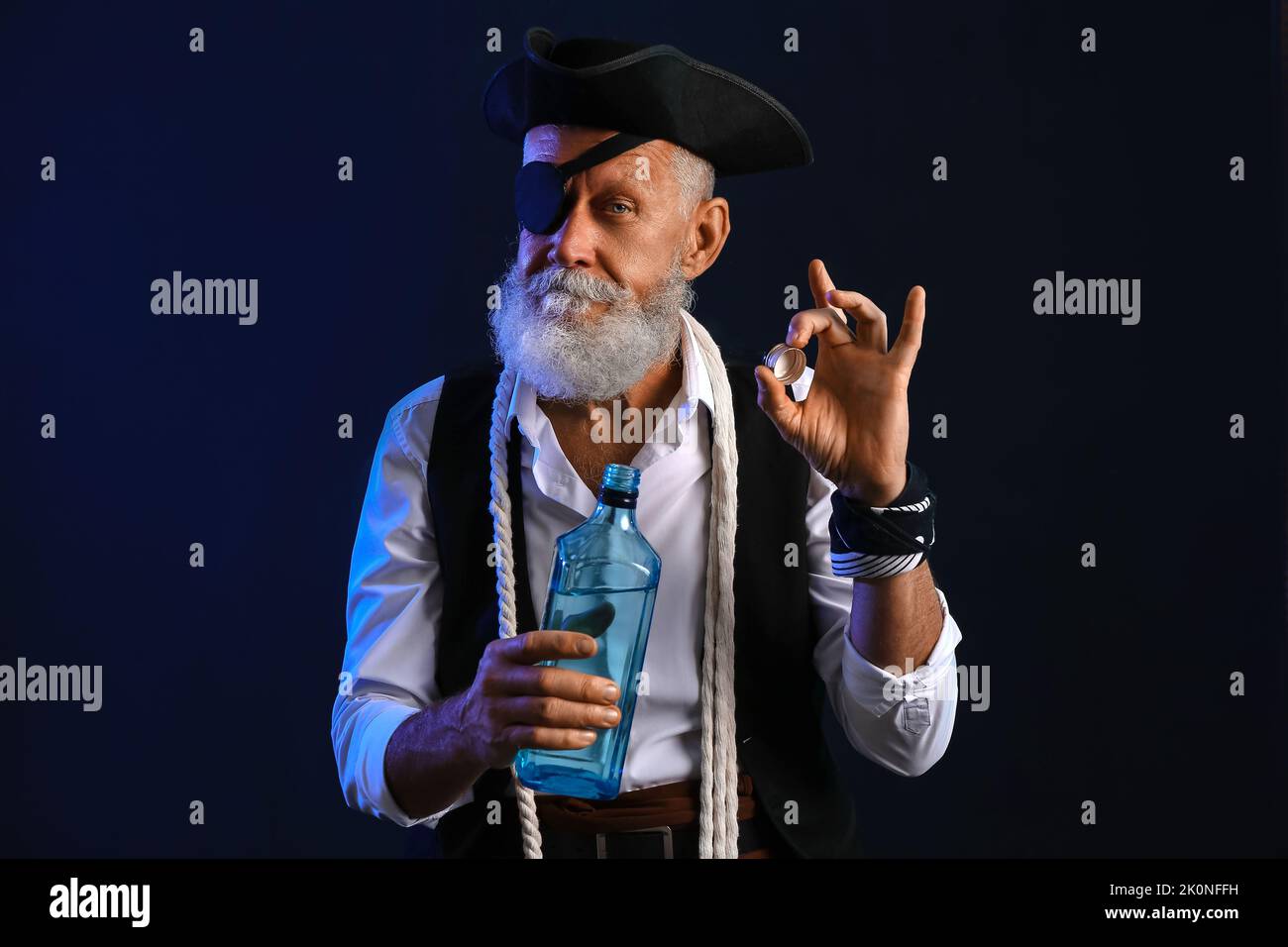Old pirate with bottle of rum on dark background Stock Photo - Alamy