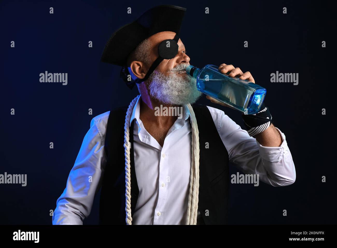 Old pirate drinking rum on dark background Stock Photo - Alamy