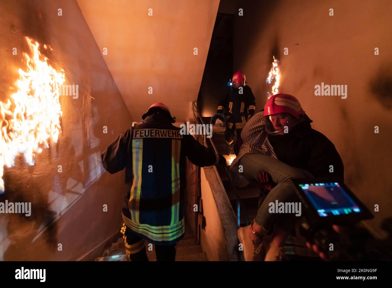 Brave Fireman Descends Stairs of a Burning Building and Holds Saved ...