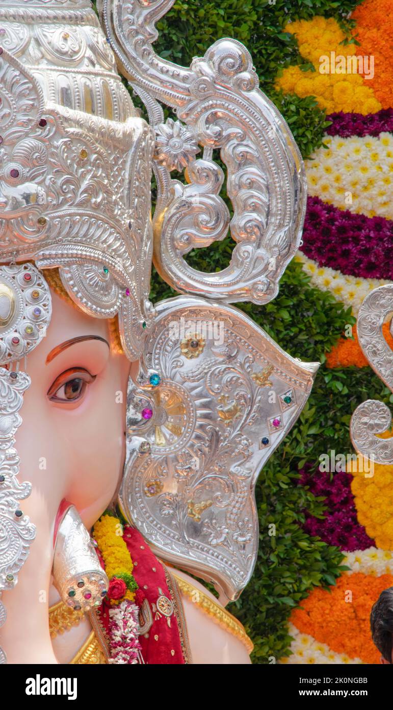 A vertical shot of The Kasba Ganapati statue's half face Stock Photo ...
