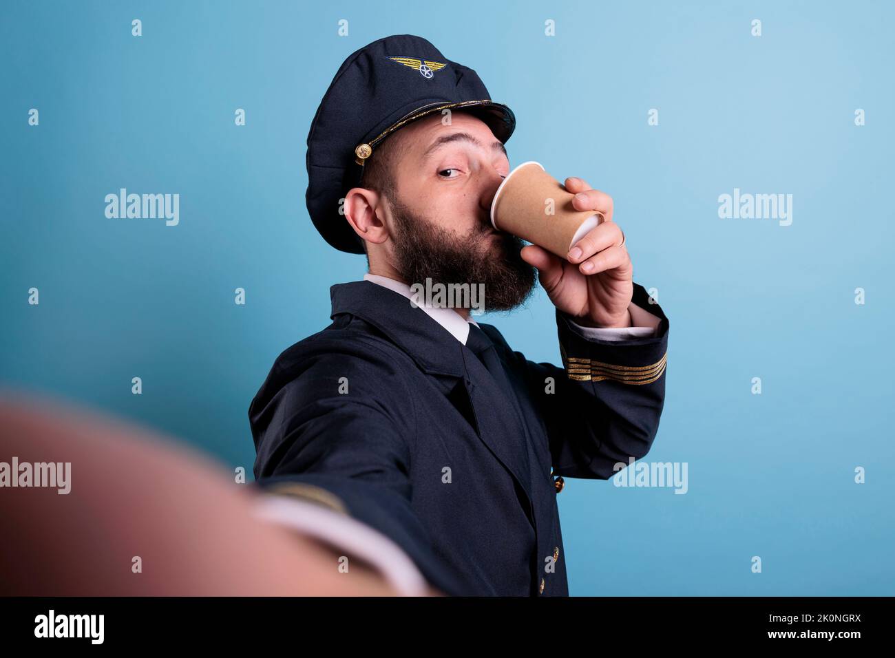 Aviator drinking coffee to go first person view, taking photo on front ...