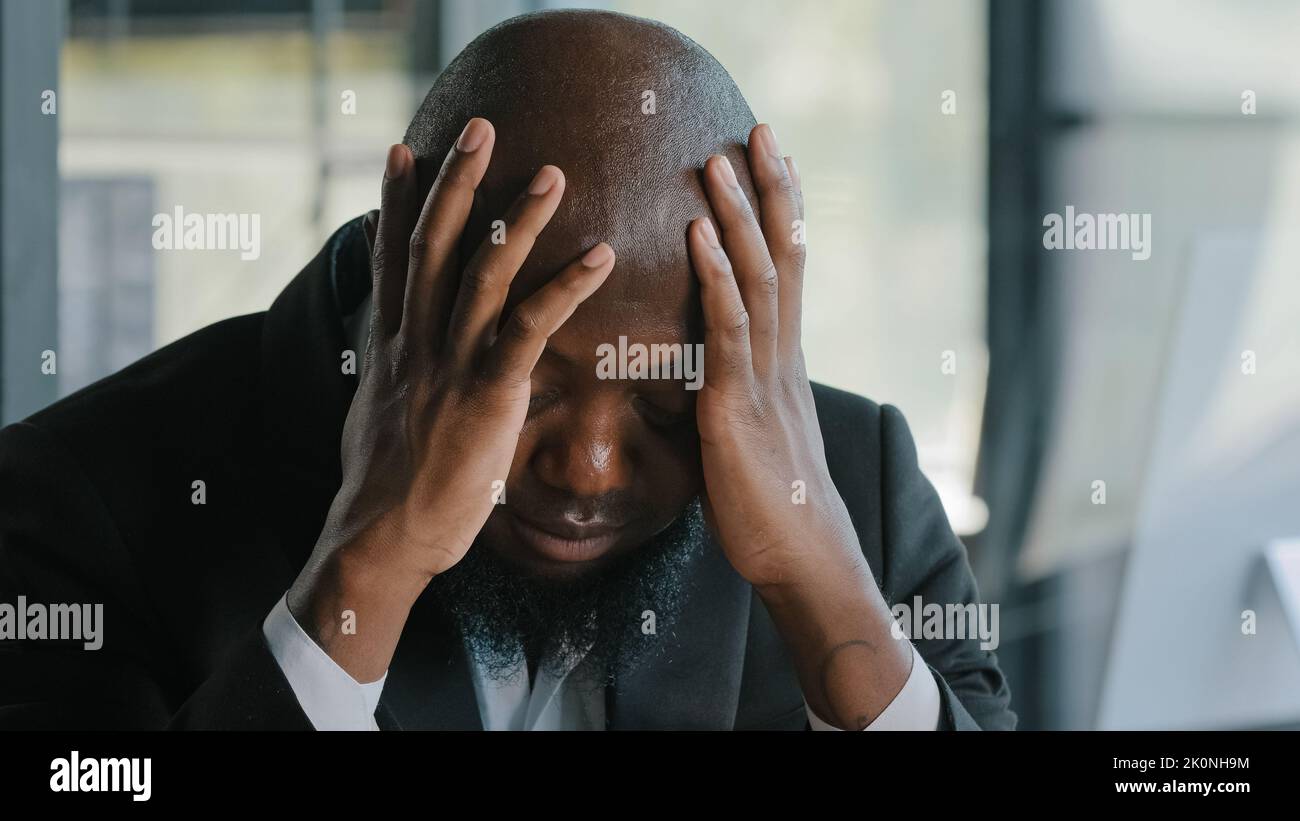 Sick exhausted african man suffer from headache migraine syndrome hold ...