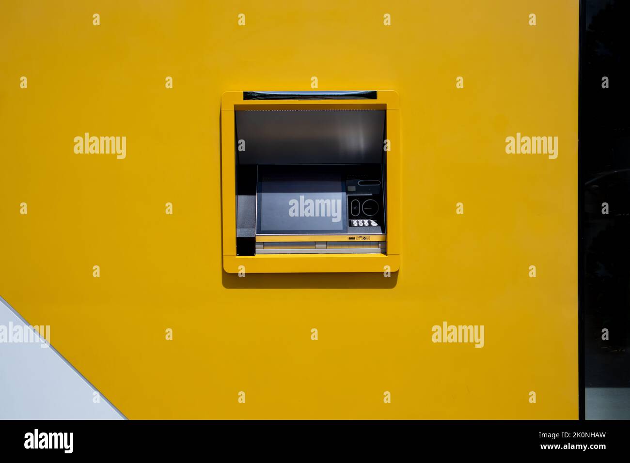 Automated teller machine (ATM). Cash dispenser on yellow wall. Account balances, withdraw ...