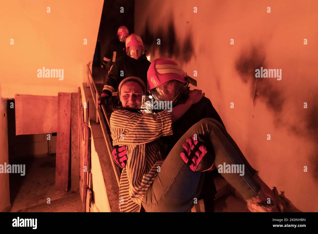 Brave Fireman Descends Stairs of a Burning Building and Holds Saved ...