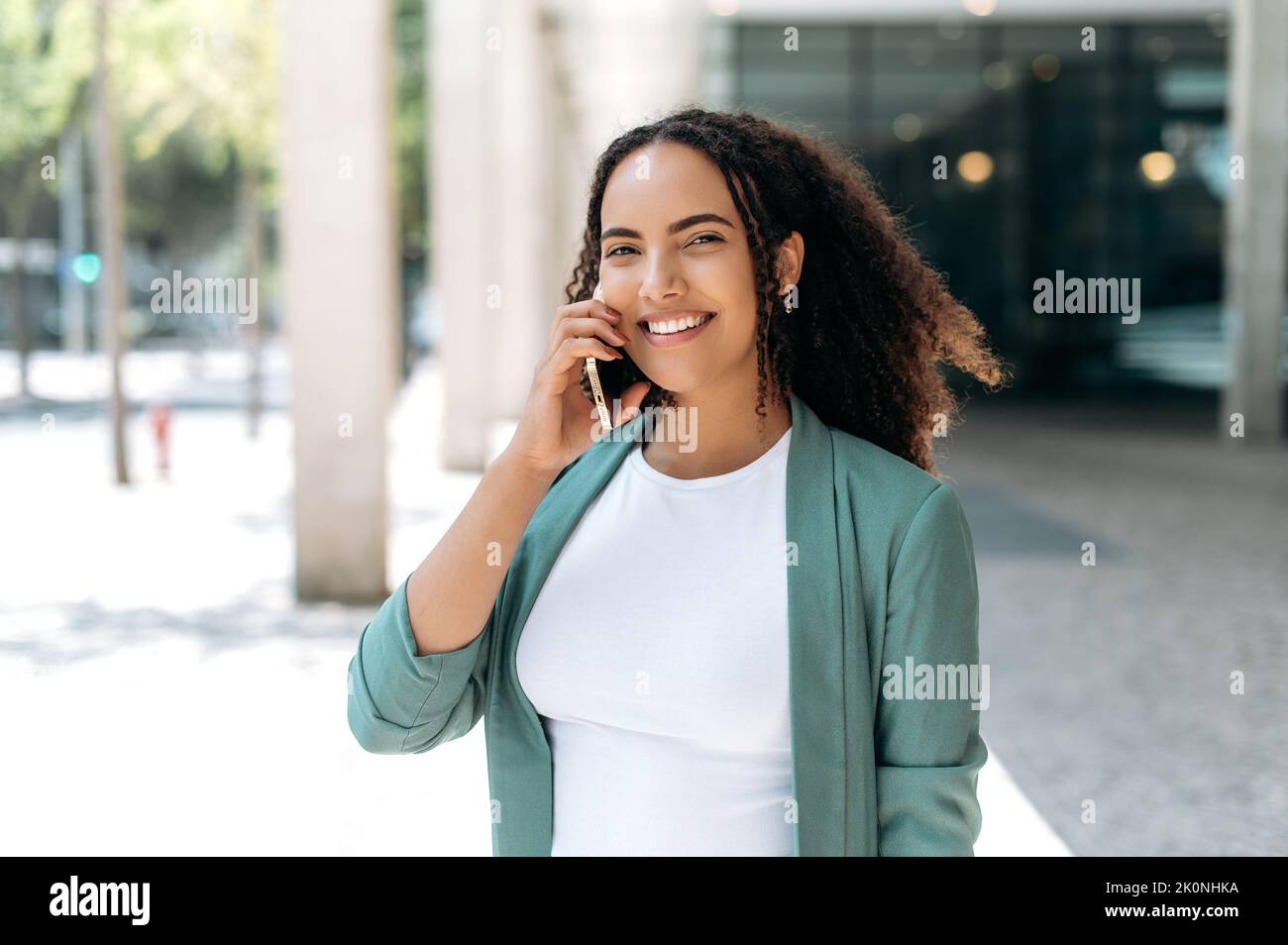 Wireless communication. Busy positive latino or brazilian woman ...