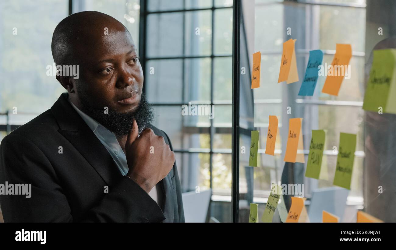 Thoughtful african entrepreneur american adult bearded male businessman ...