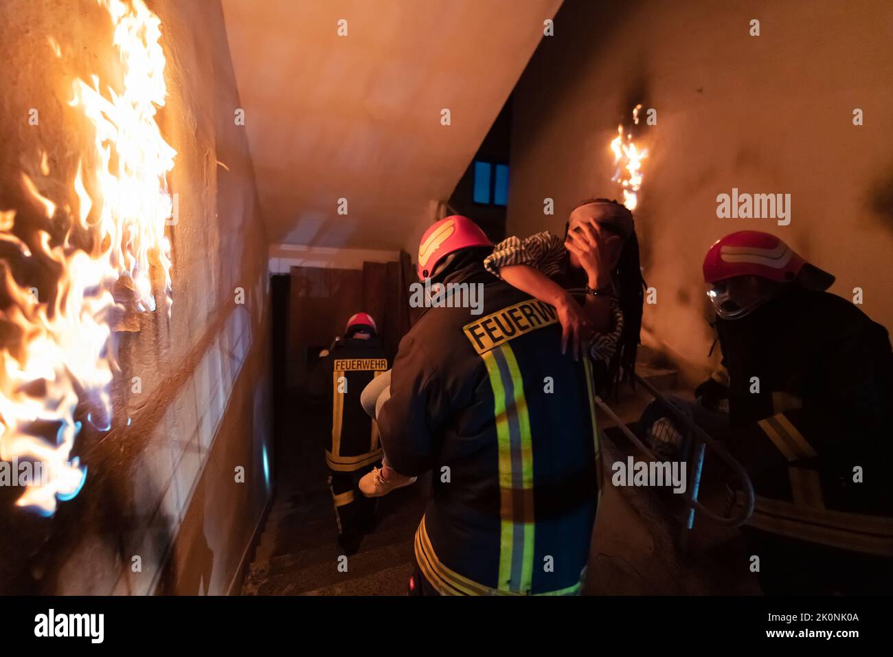Brave Fireman Descends Stairs of a Burning Building and Holds Saved ...