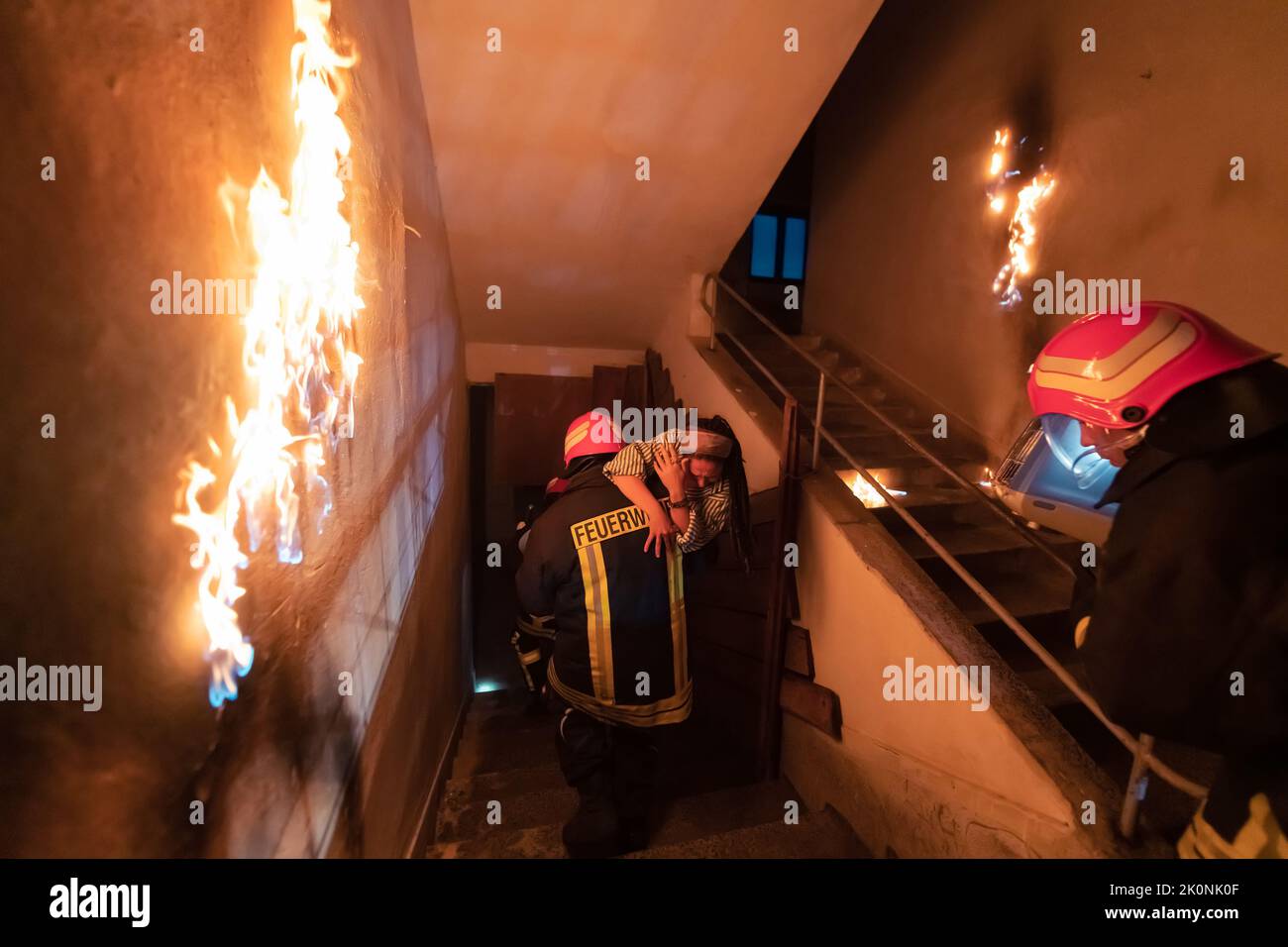 Brave Fireman Descends Stairs of a Burning Building and Holds Saved ...