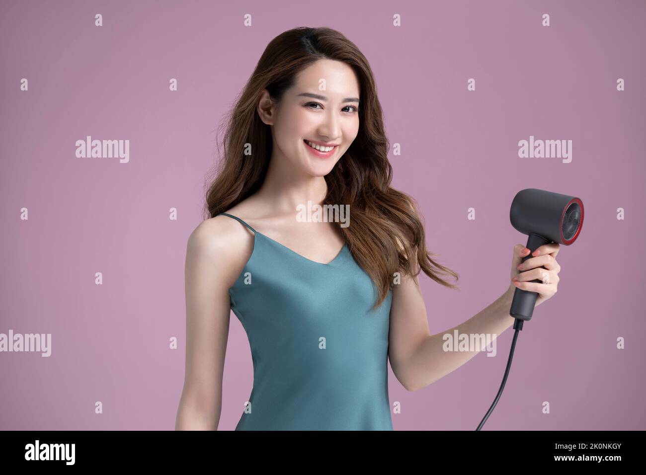 Woman using hair dryer hi-res stock photography and images - Alamy