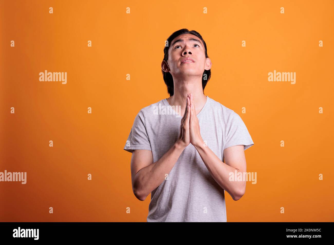 Young man praying folding hands, faith, worship concept. Religious ...