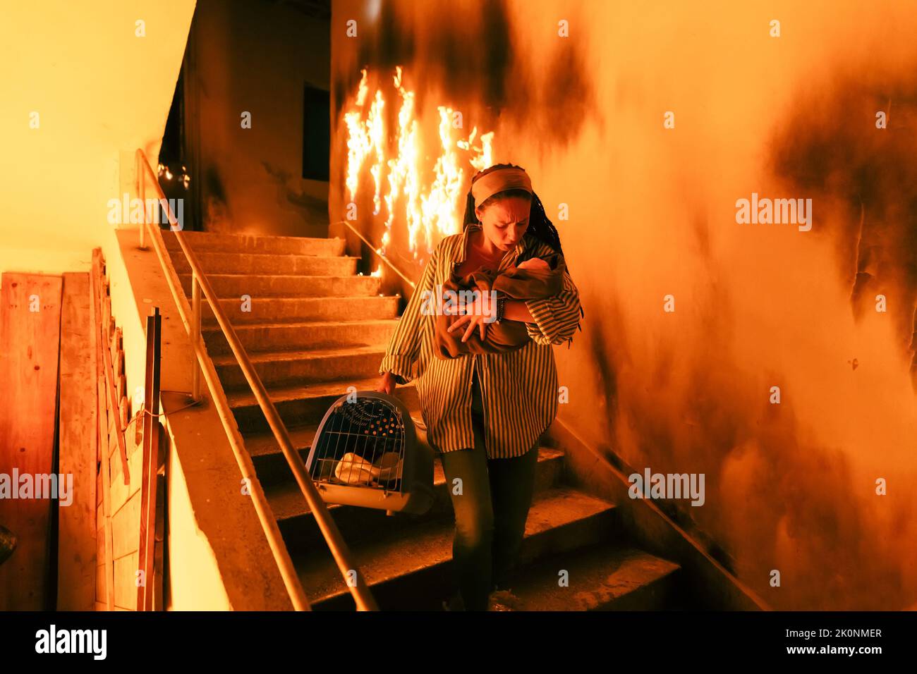 Brave Fireman Descends Stairs of a Burning Building and Holds Saved ...