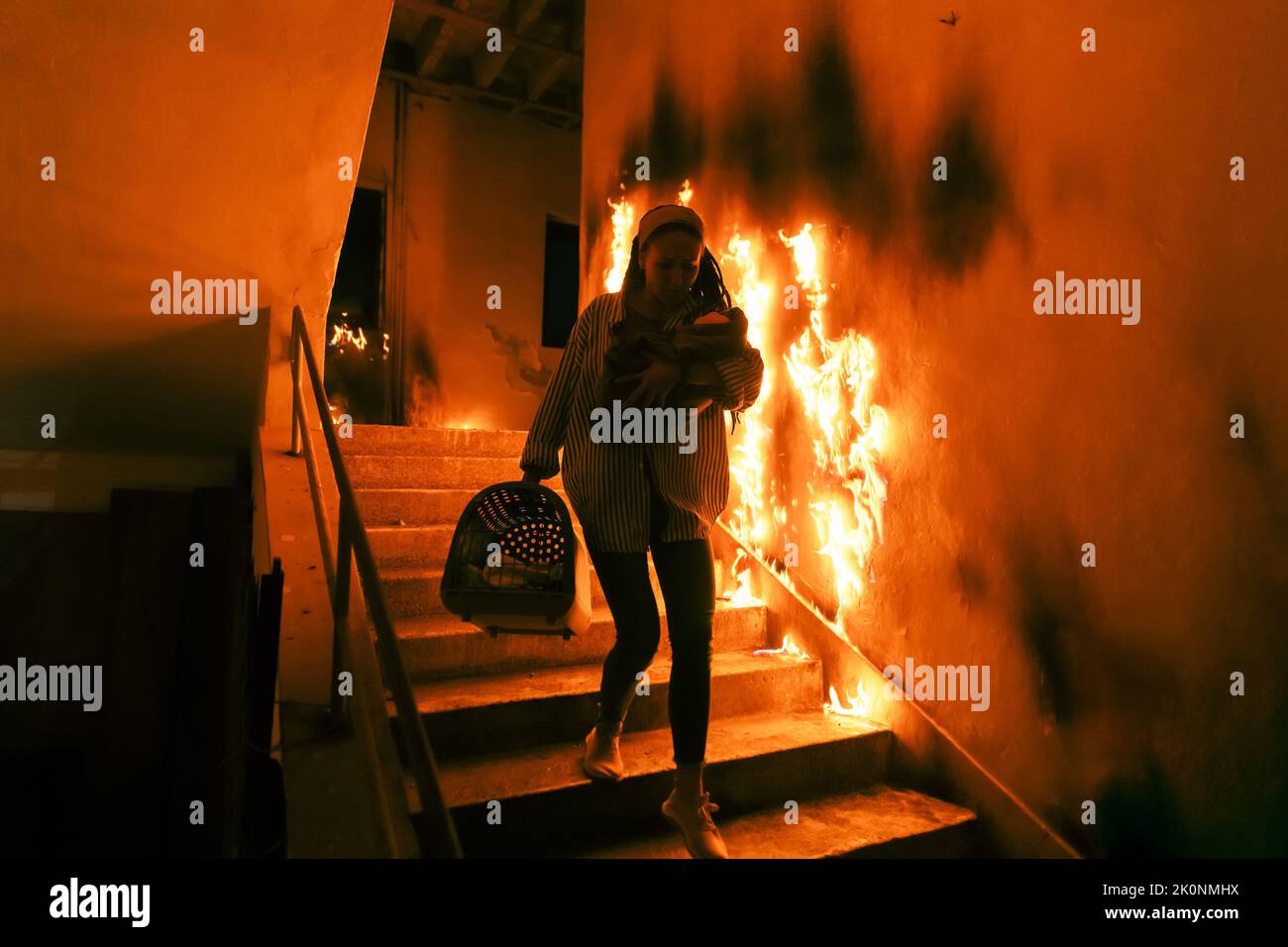 Brave Fireman Descends Stairs of a Burning Building and Holds Saved ...