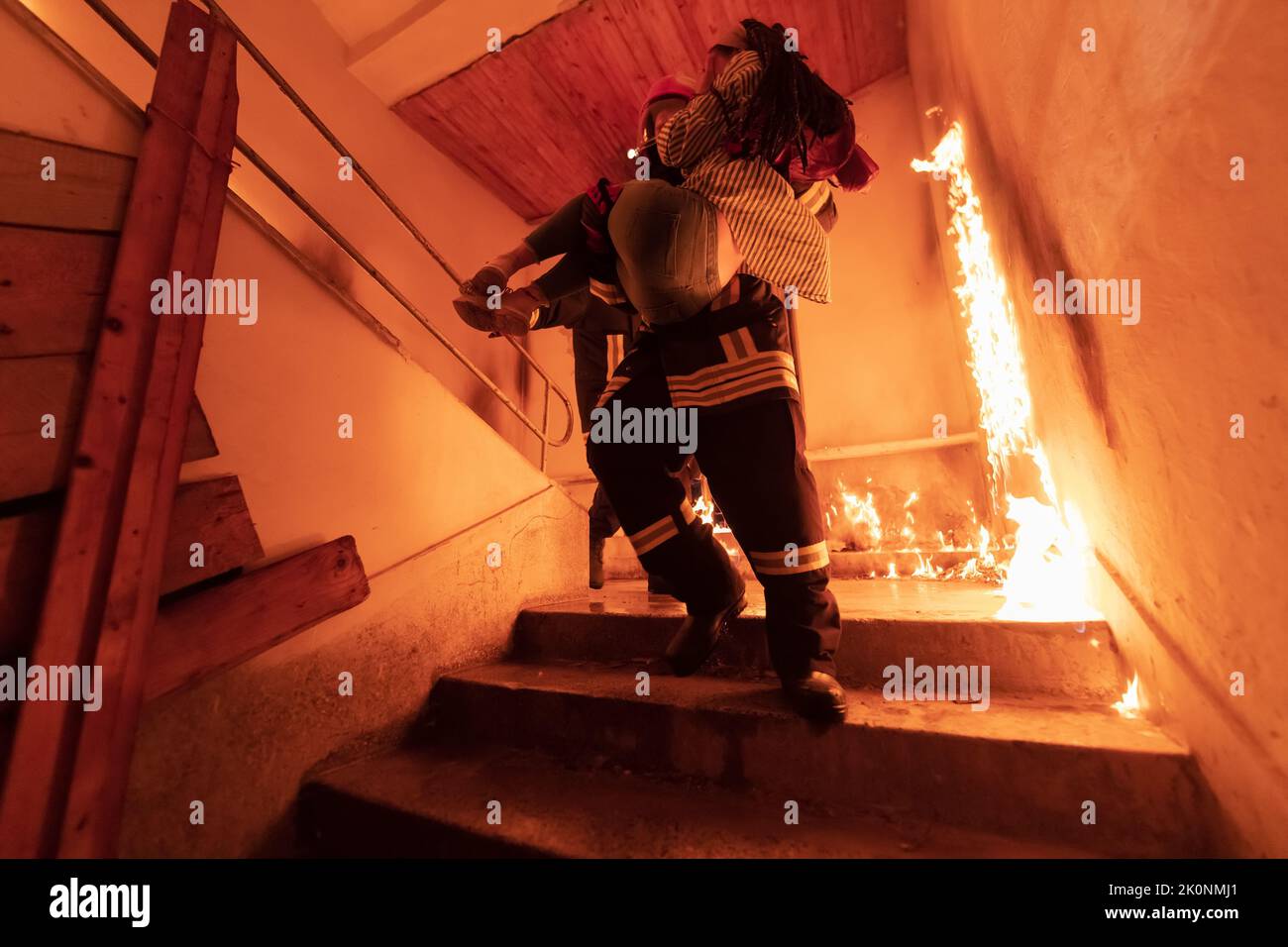 Brave Fireman Descends Stairs of a Burning Building and Holds Saved ...