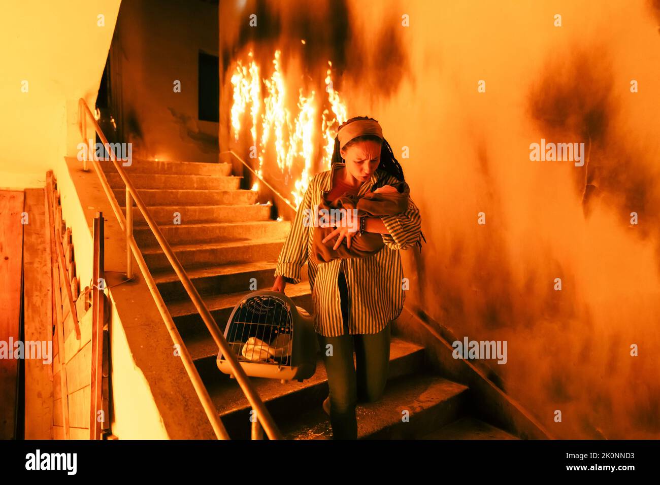 Brave Fireman Descends Stairs of a Burning Building and Holds Saved ...
