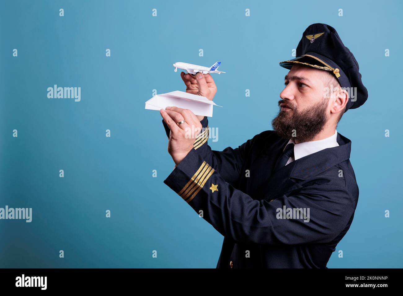 Airplane aviator holding jet toy and paper plane in hands front view ...