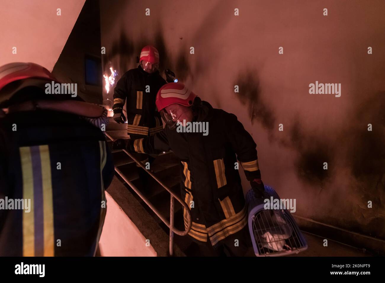 Brave Fireman Descends Stairs of a Burning Building and Holds Saved ...