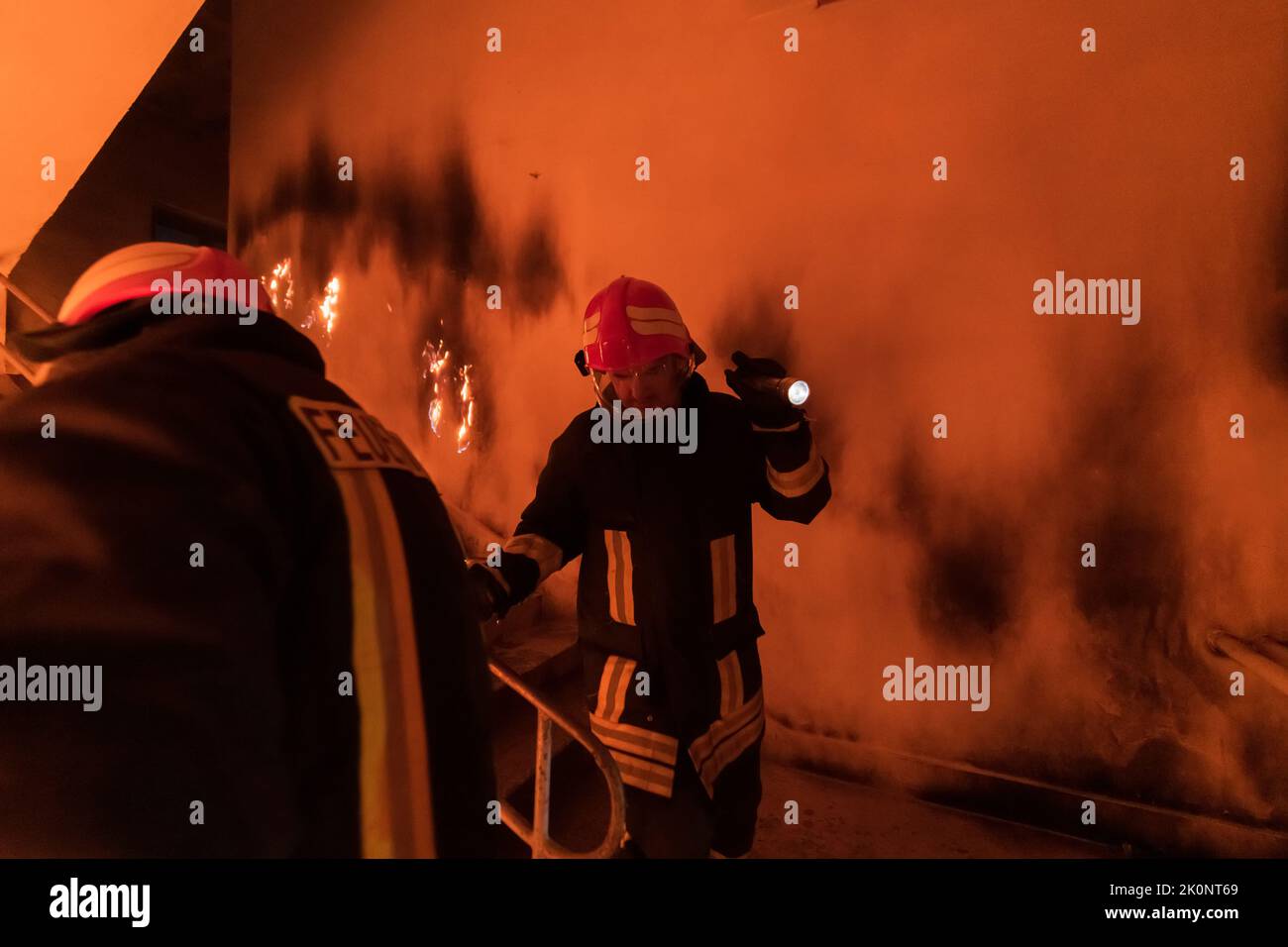 Brave Fireman Descends Stairs of a Burning Building and Holds Saved ...