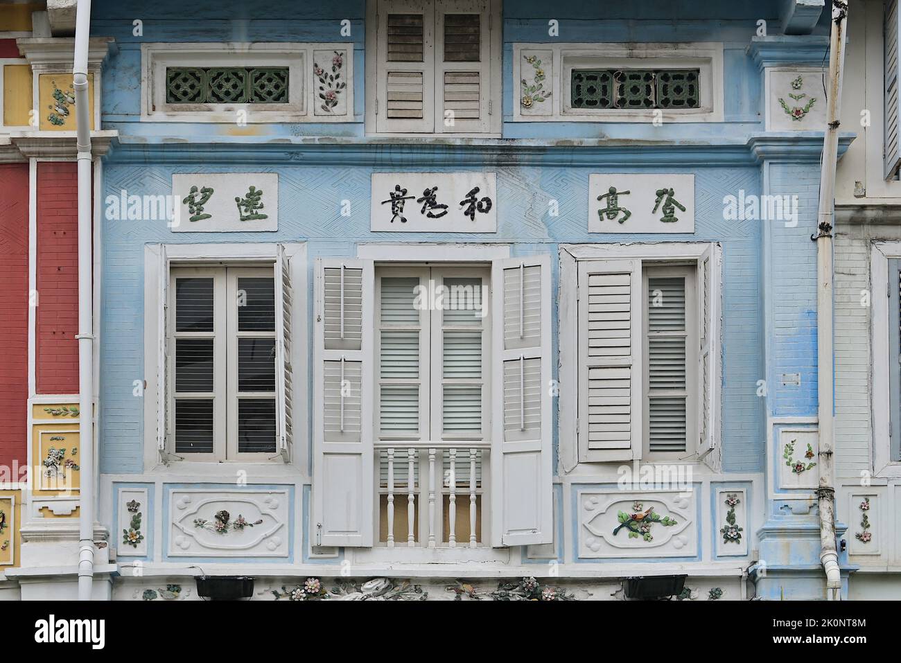 Faded light blue Straits Chinese Peranakan shophouse exterior with ...
