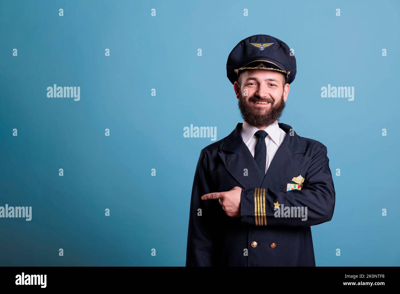 Airplane pilot pointing in side direction with index finger ...