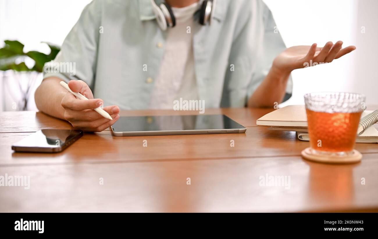 A hipster young Asian man graphic designer using digital tablet to ...