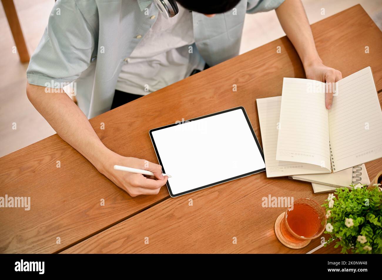 Talented young Asian male college student doing his homework, lecturing ...