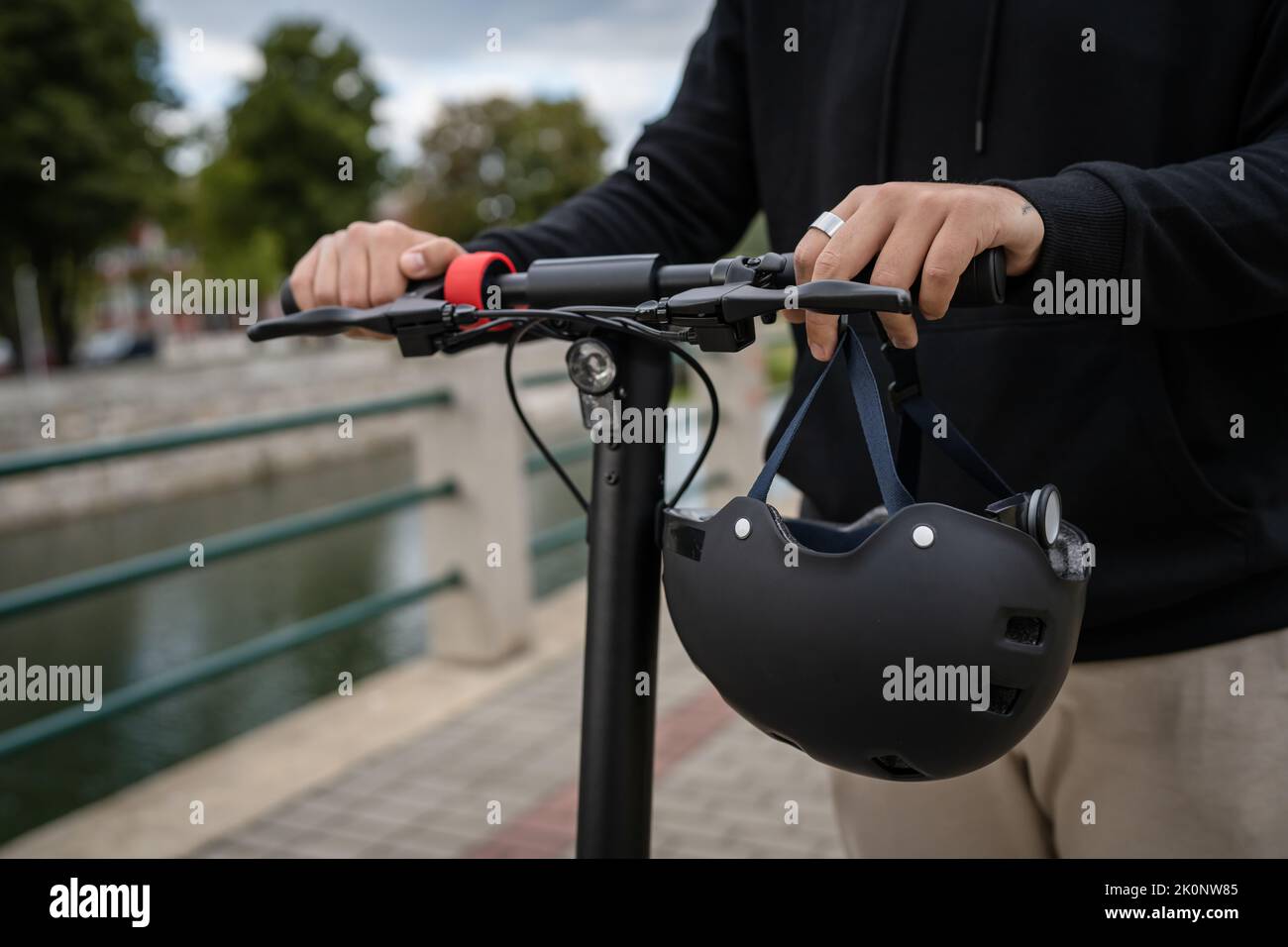 One adult caucasian man standing or riding drive electric kick scooter ...