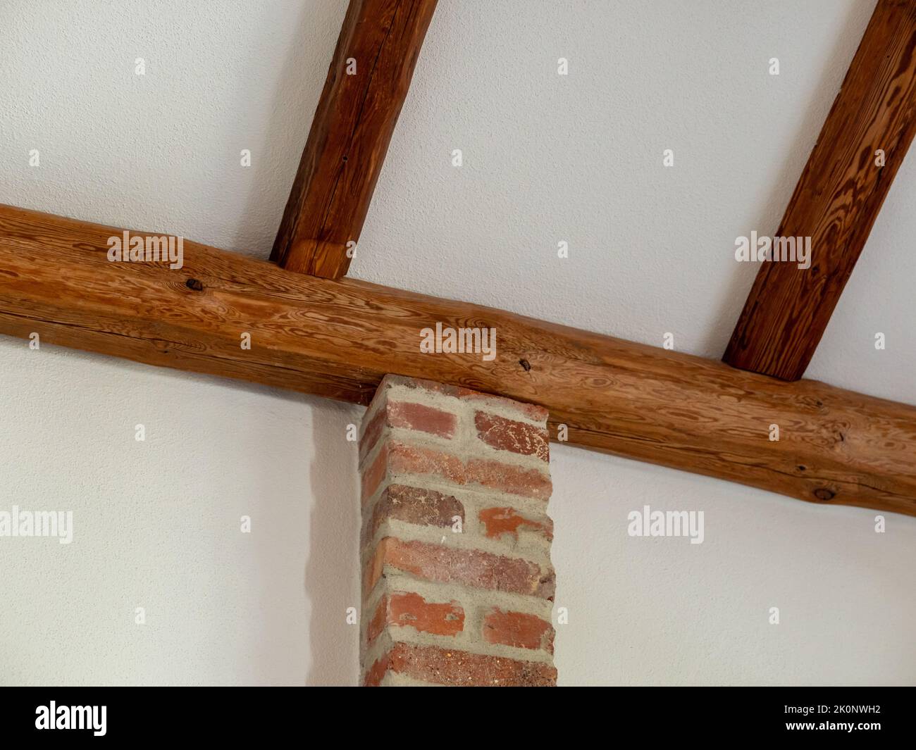 Red brick stone post as supporting structure in an old house. The ...