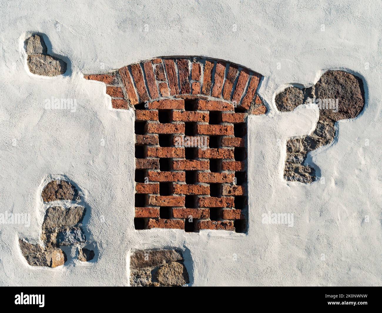 Old facade with ventilation holes in the masonry wall. Renovated ...