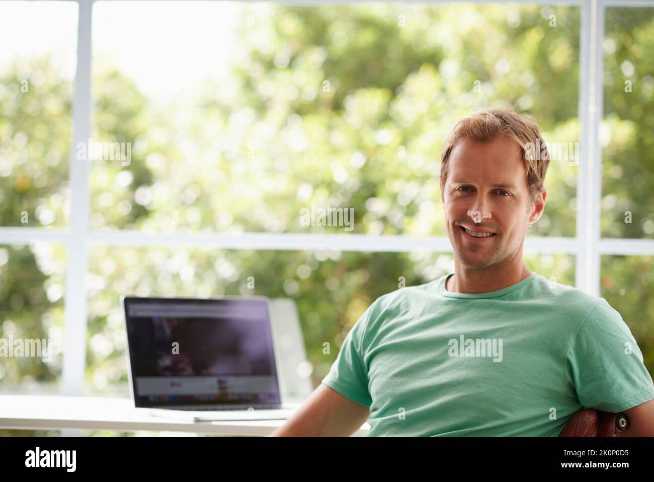 Laid back and relaxed on the weekend. a handsome young man at home ...