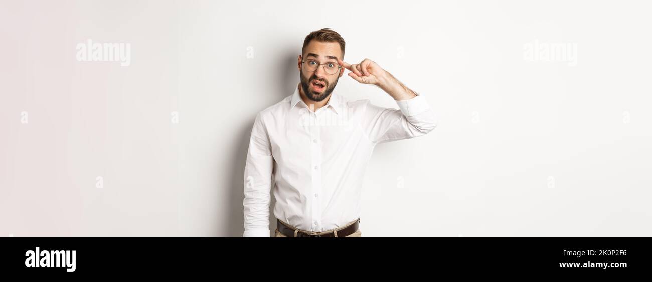 Confused man pointing at head, scolding employee, reaction on something ...