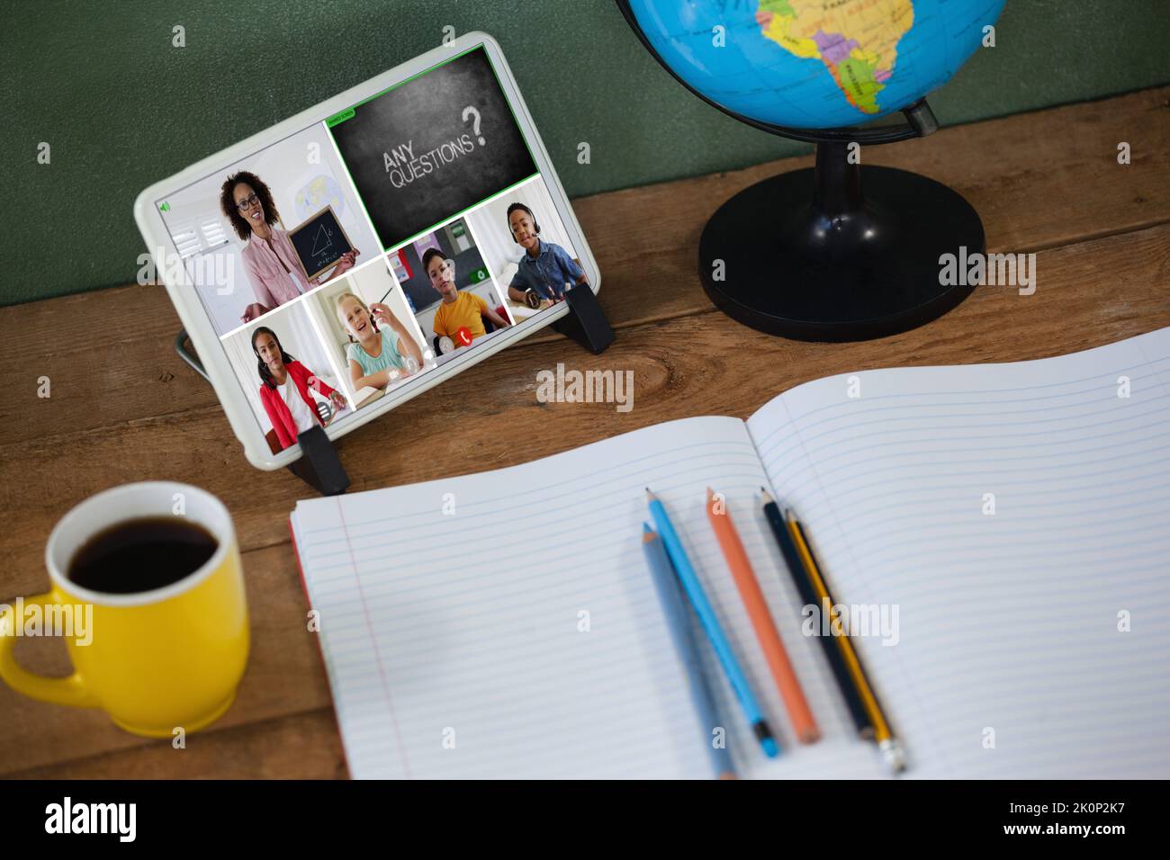 Smiling diverse elementary school pupils during class on tablet screen ...