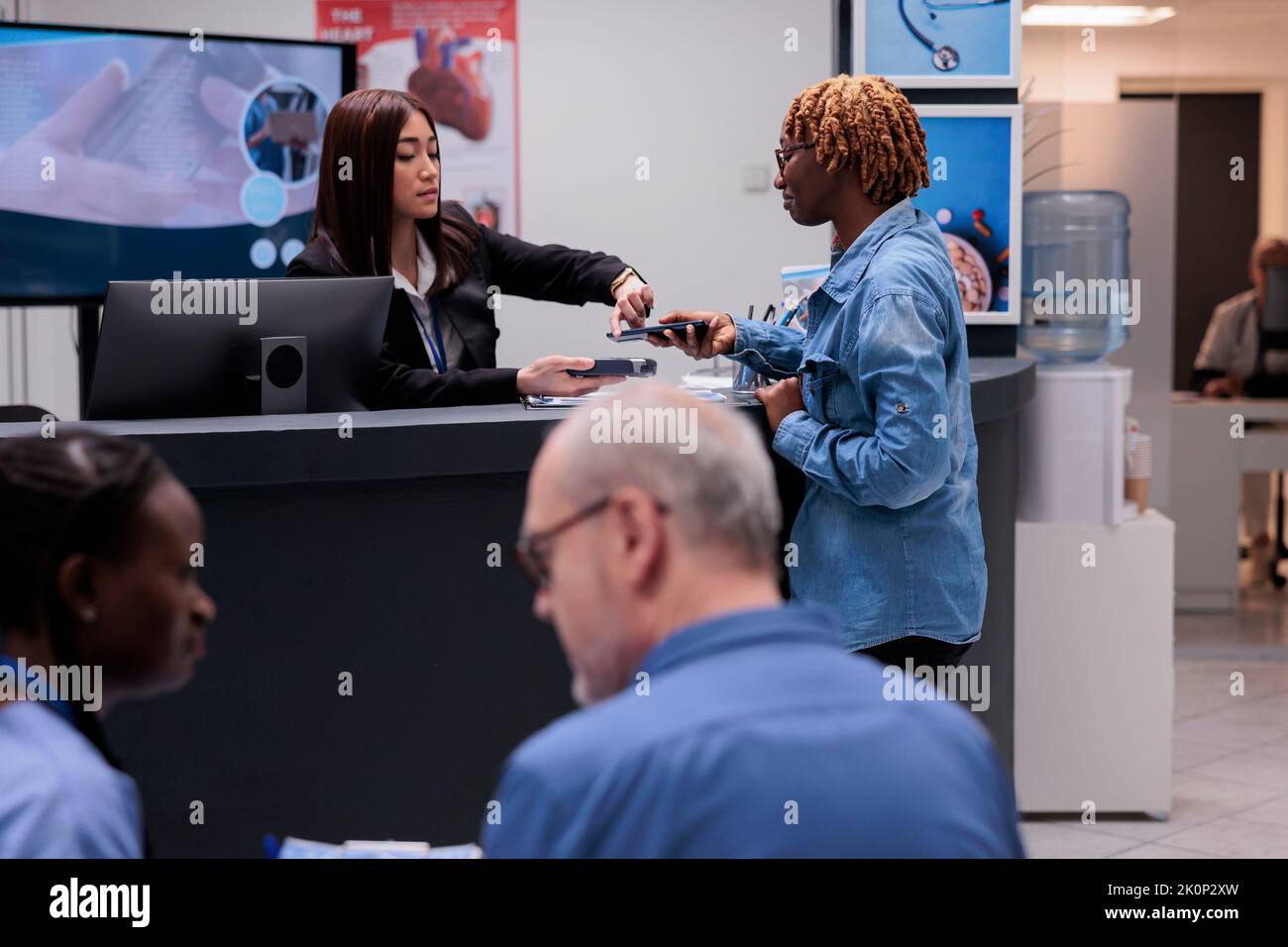 African american patient paying examination with credit card ...