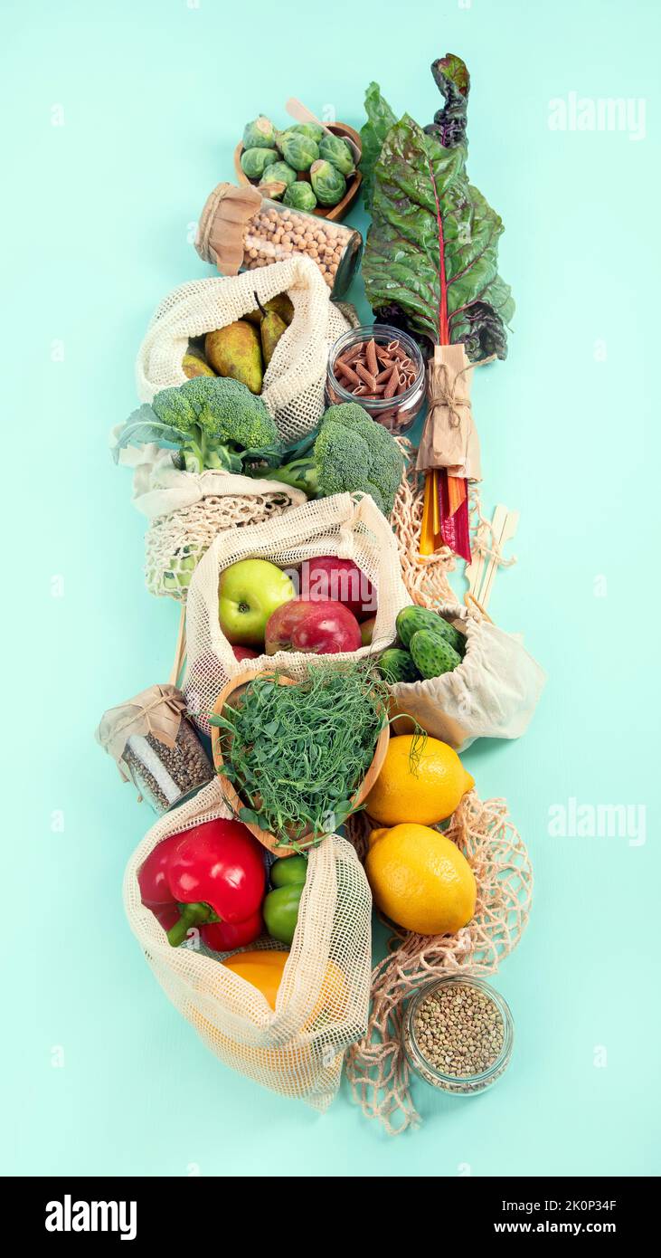 Various organic fruits and vegetables in reusable packaging bags. Eco ...