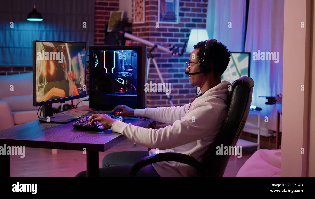 African american gamer playing online multiplayer game celebrating ...