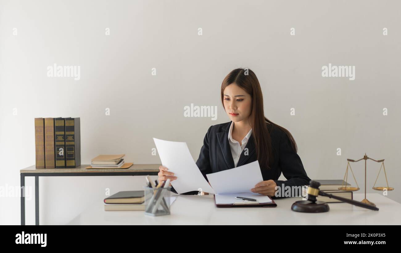 Law concept, Female lawyer is reading contract about legal regulations ...
